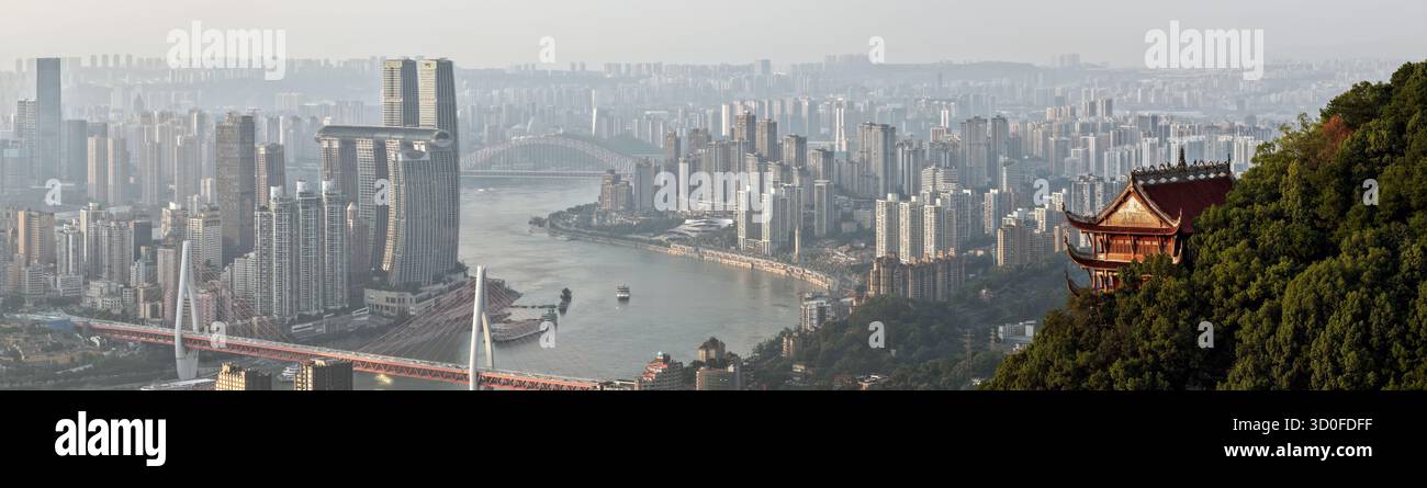Aerial view of Chongqing's skyline shimmers in the sunset, bridges arch ...