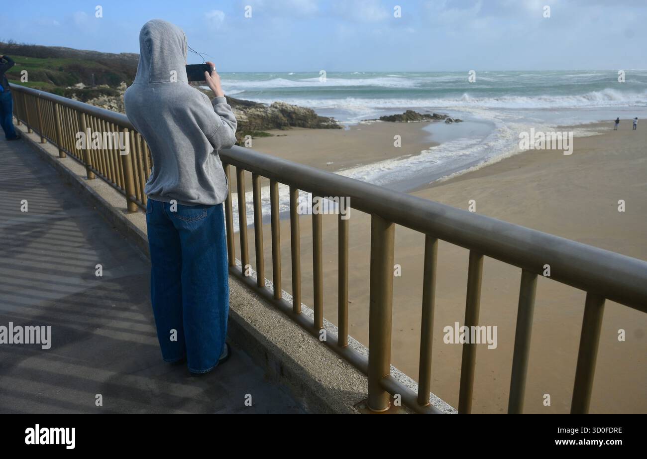 A person takes pictures of the swell, on October 23, 2025, in Santander ...