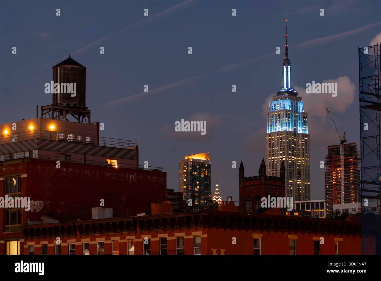 View of the illuminated Empire State Building piercing the night sky ...