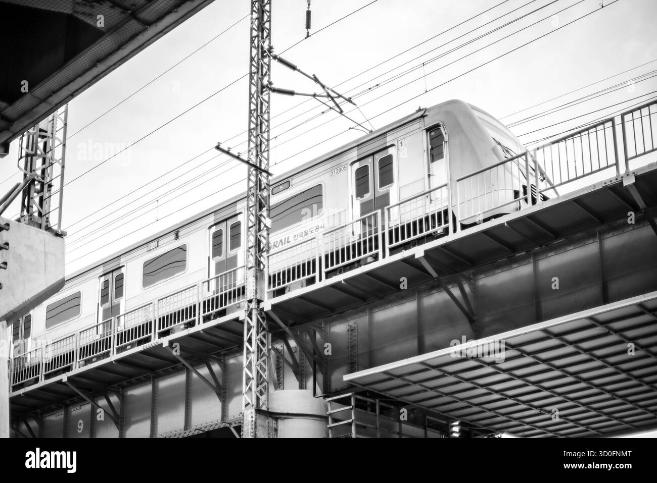 Black and white photo of a Korean rail train on an elevated track in ...