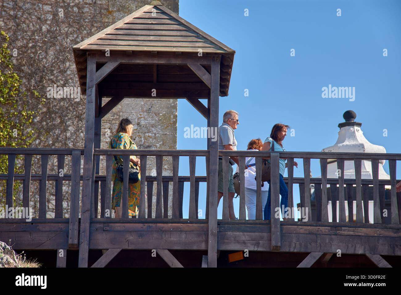 A group of retired men and women are shown strolling and exploring the ...
