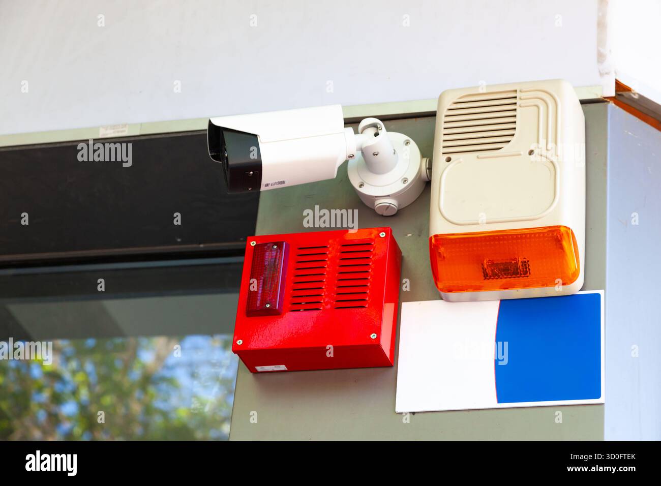 Alarm devices and a video camera hanging on the wall of the building ...