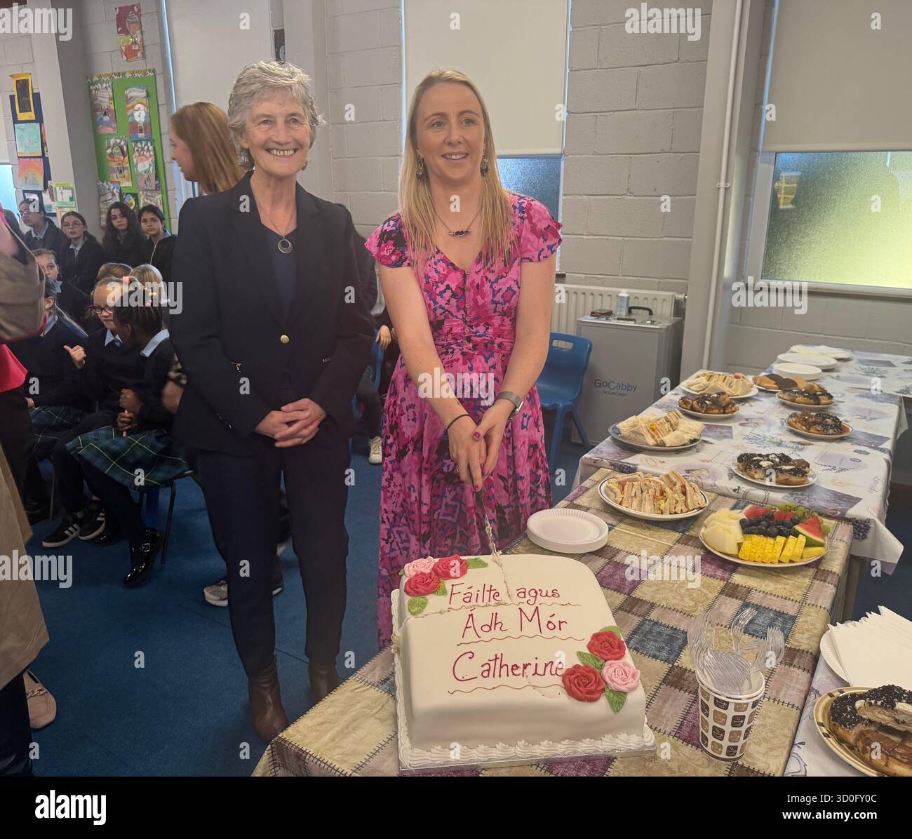 Presidential candidate Catherine Connolly (left) with the head teacher ...