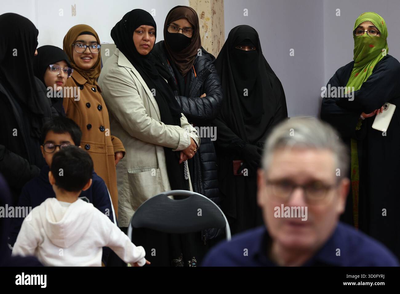 Women watch as Britain's Prime Minister Keir Starmer speaks during a ...