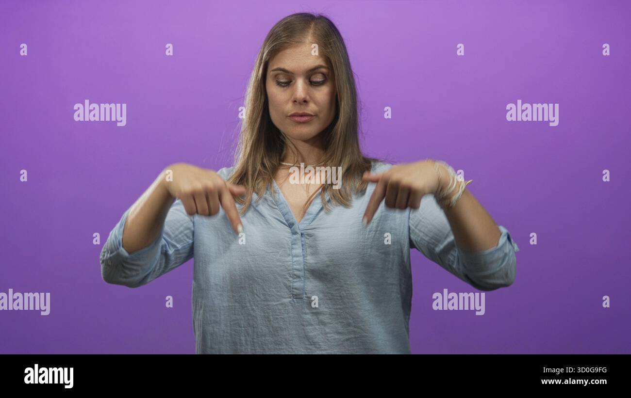 Woman points fingers downward in hi-res stock photography and images ...