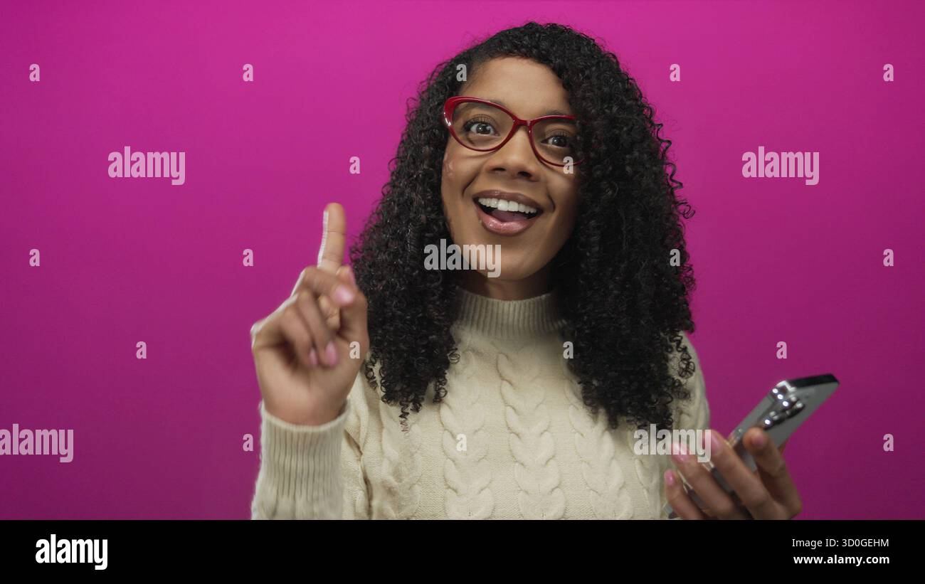 Woman scratches head holding smartphone in studio setting with bright ...
