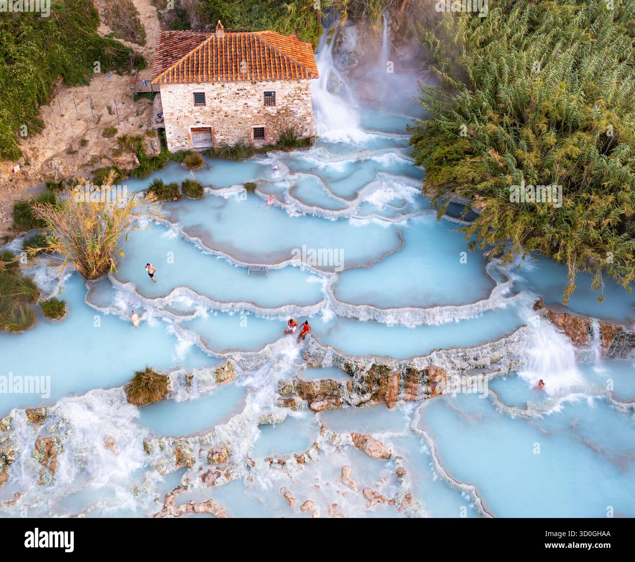 Aerial view of cascading turquoise waters flow down travertine terraces ...