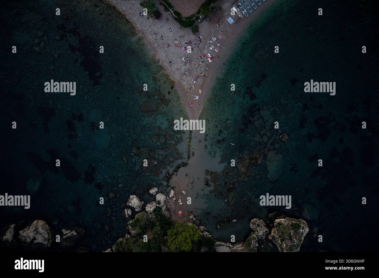 Aerial view of the beach where the land splits the turquoise sea ...