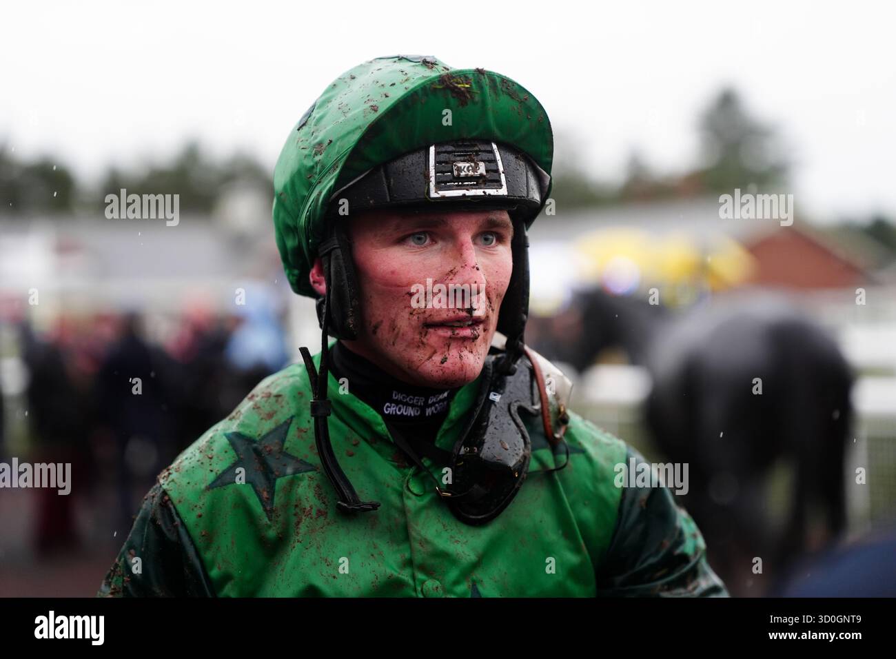 Jockey Jonathan Burke, covered in mud following the David Pugh Memorial ...