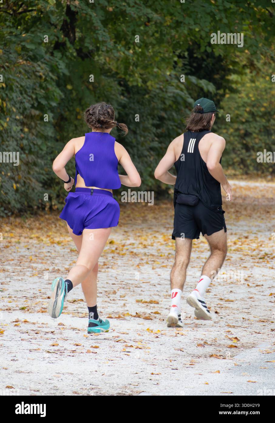 Couple jogging through autumn forest hi-res stock photography and ...