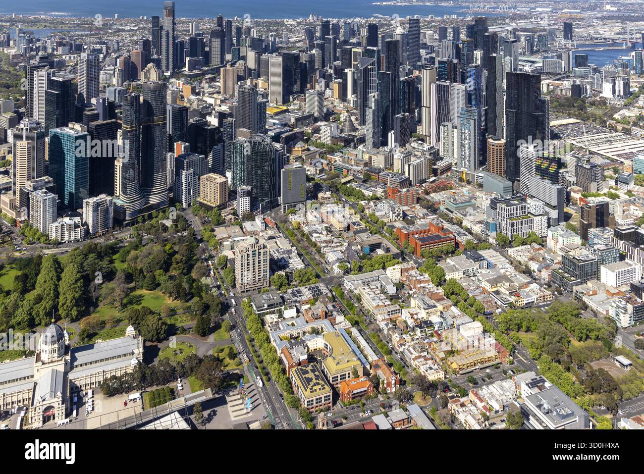 Aerial view of sunlight casting shadows across the towering skyscrapers ...