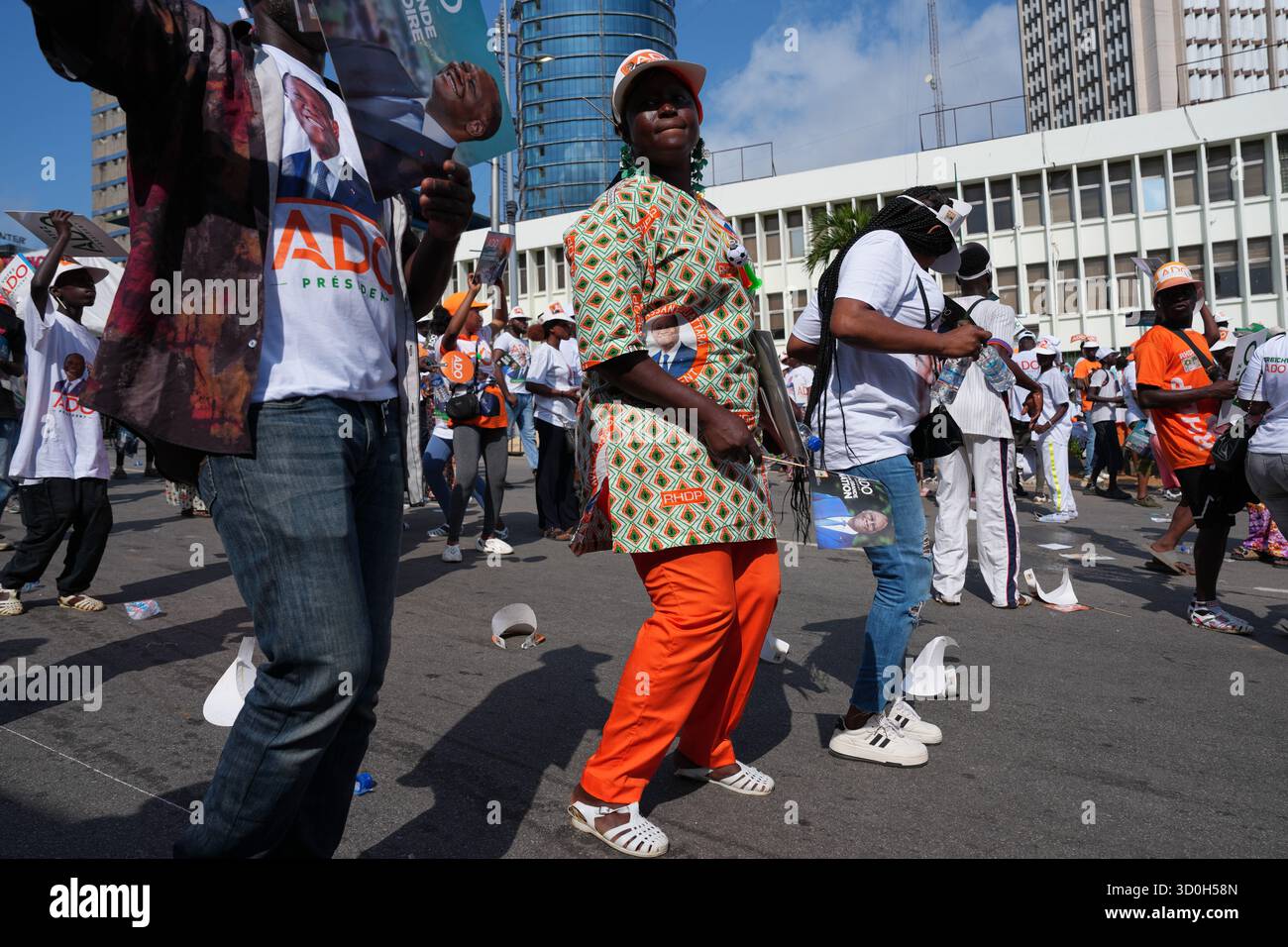 Supporters of President Alassane Ouattara dance during a rally in ...
