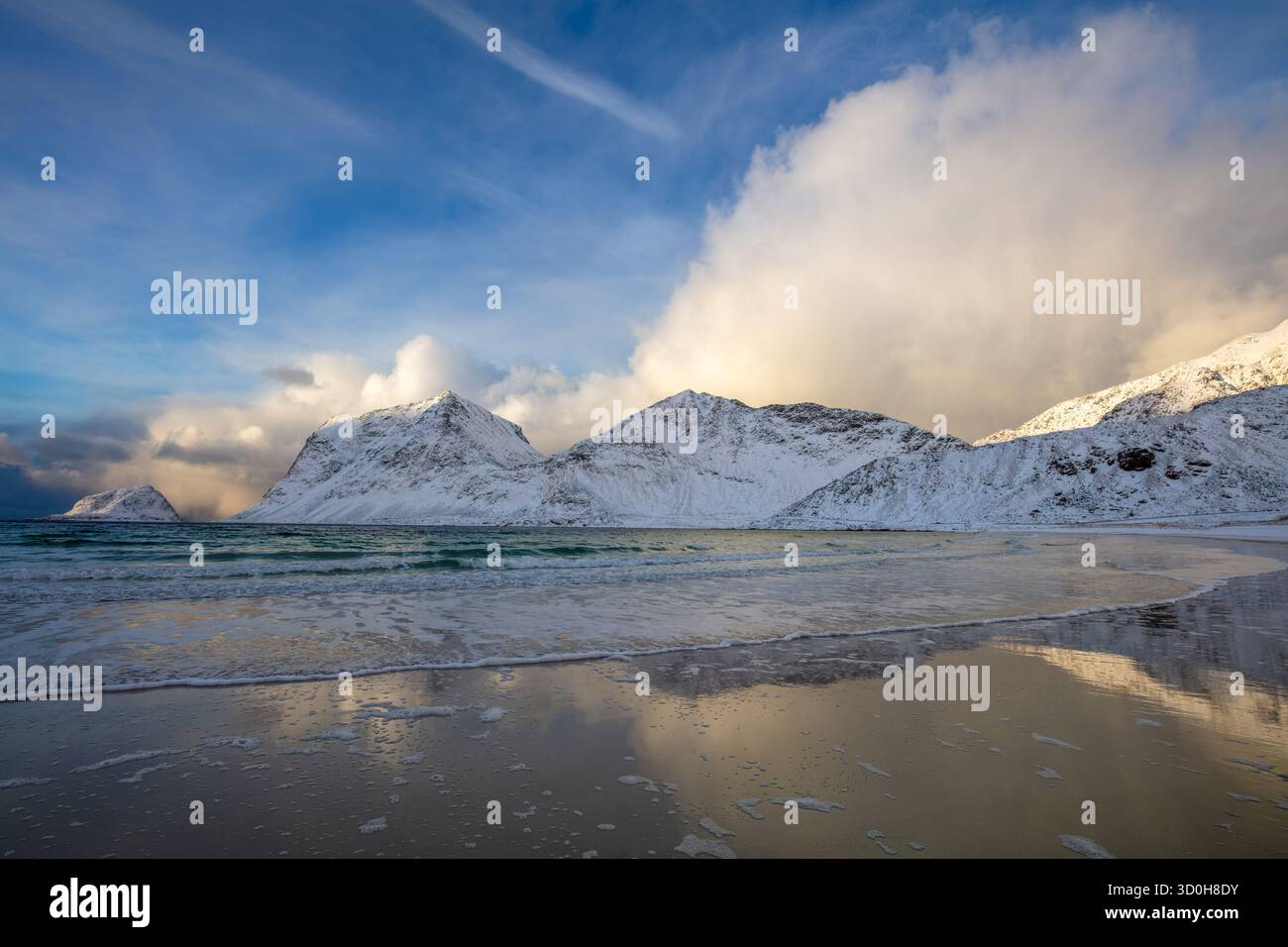 Winter in Norway. A long surf wave on a beach on the shore of a fjord ...