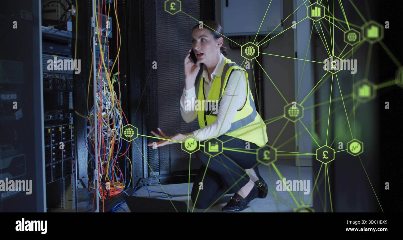 Kneeling tech wearing safety vest checking cables in data center, neon ...