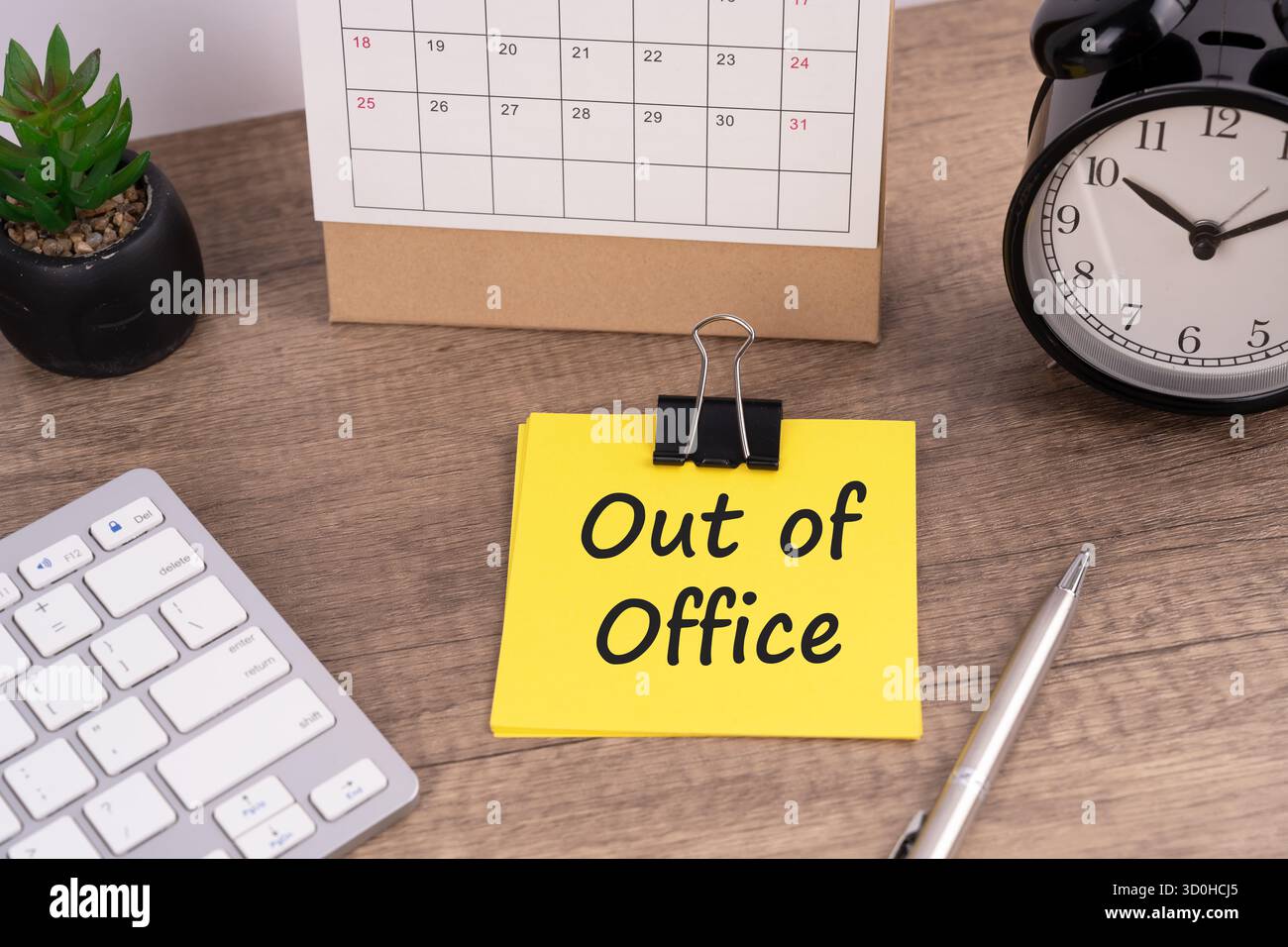 Out of office text on a paper note Stock Photo - Alamy