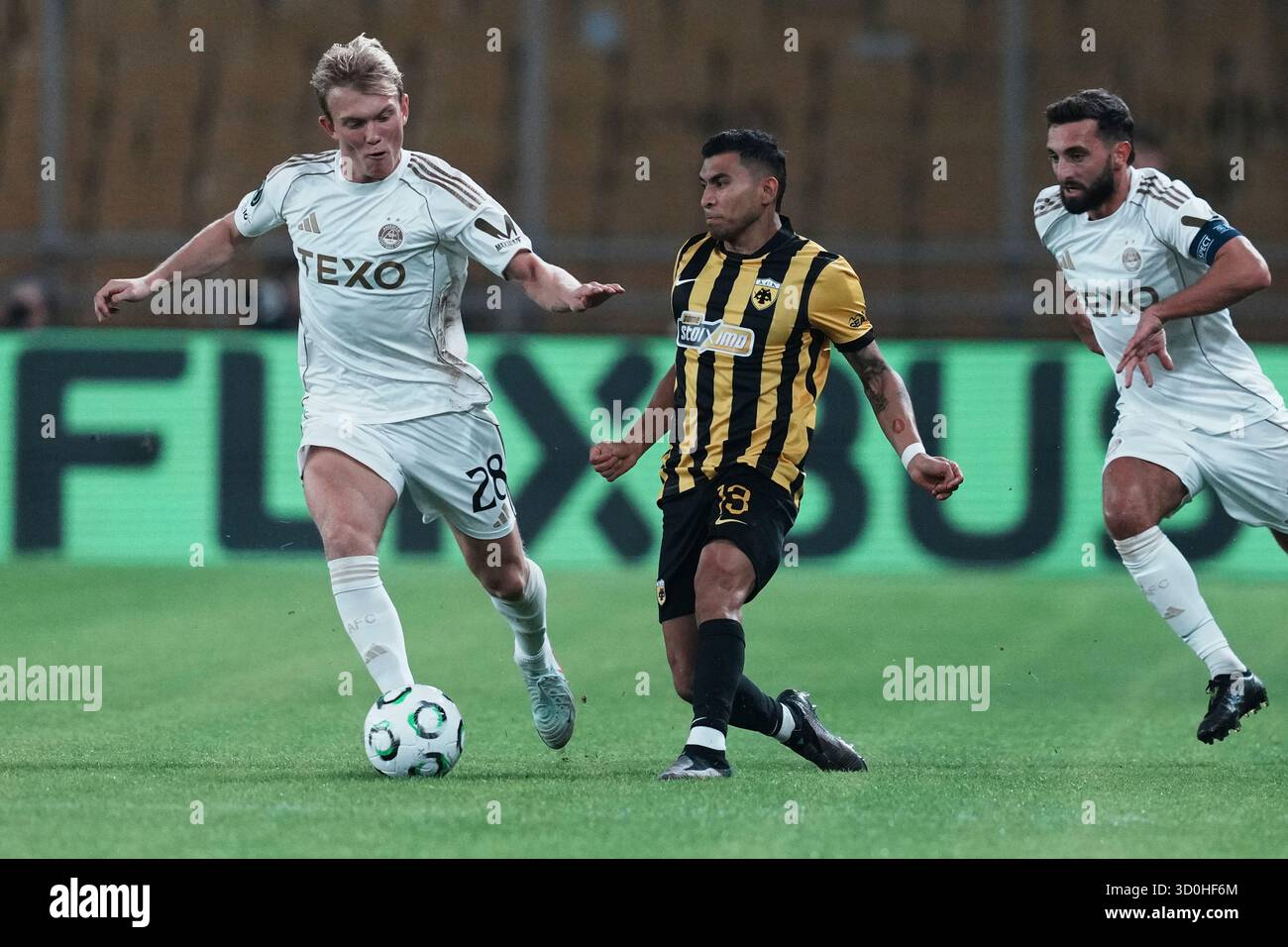 Aberdeen's Alexander Jensen, left, is challenged by AEK Athens' Orbelin Pineda during the ...