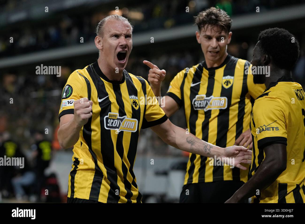 AEK Athens' Domagoj Vida, left, celebrates after his teammate ...