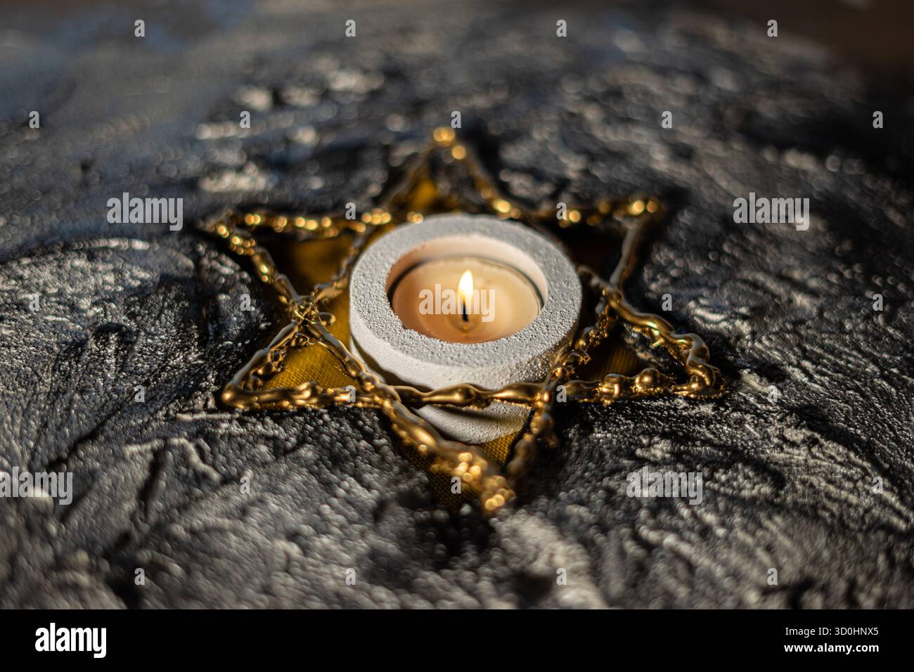 Wax candle and star of David on gray textured background. Holocaust ...
