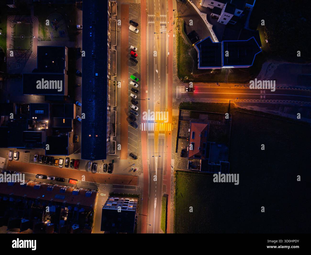 Aerial night view of urban intersection bright streetlights illuminate ...