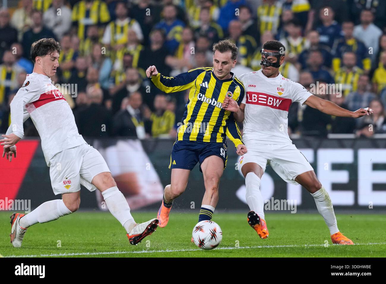 Fenerbahce's Kerem Akturkoglu, center, fights for the ball with ...