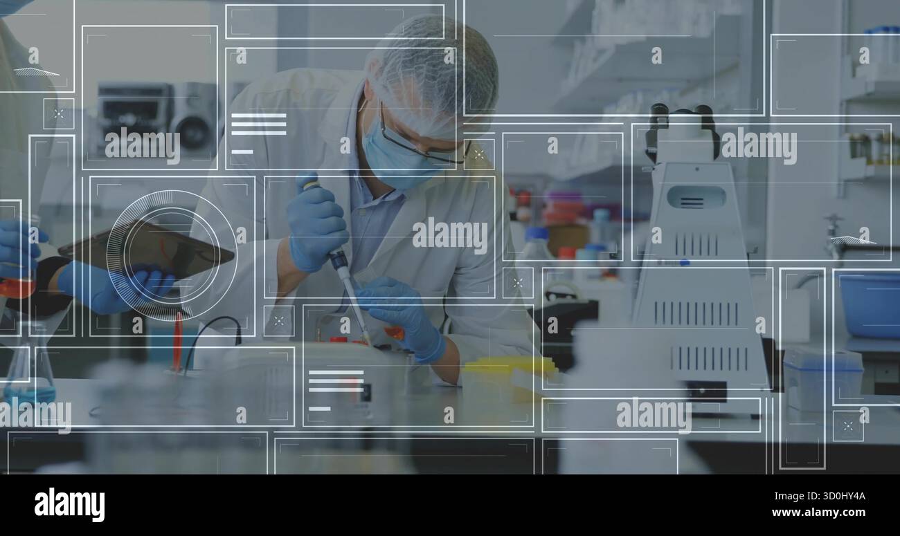 Pipetting male scientist wearing lab coat at steel bench in research ...