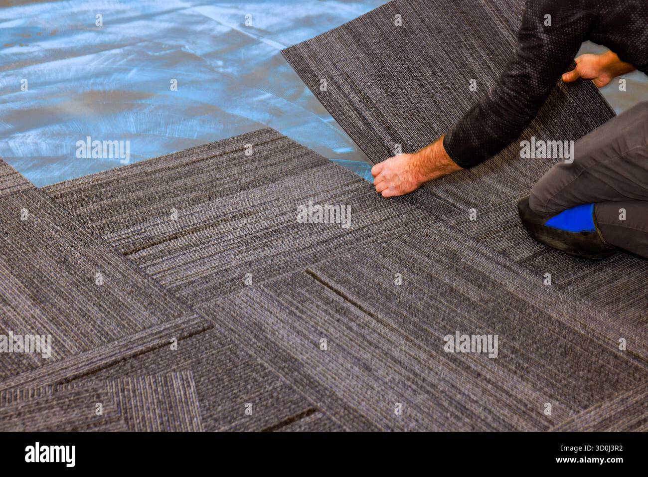 Worker laying down carpet tiles hi-res stock photography and images - Alamy