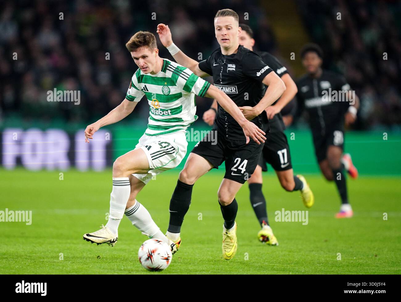 Celtic's Johnny Kenny (left) and Sturm Graz's Dimitri Lavelee battle ...