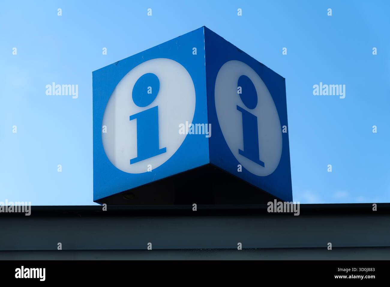 A blue information sign with a white letter on each side, set against a ...
