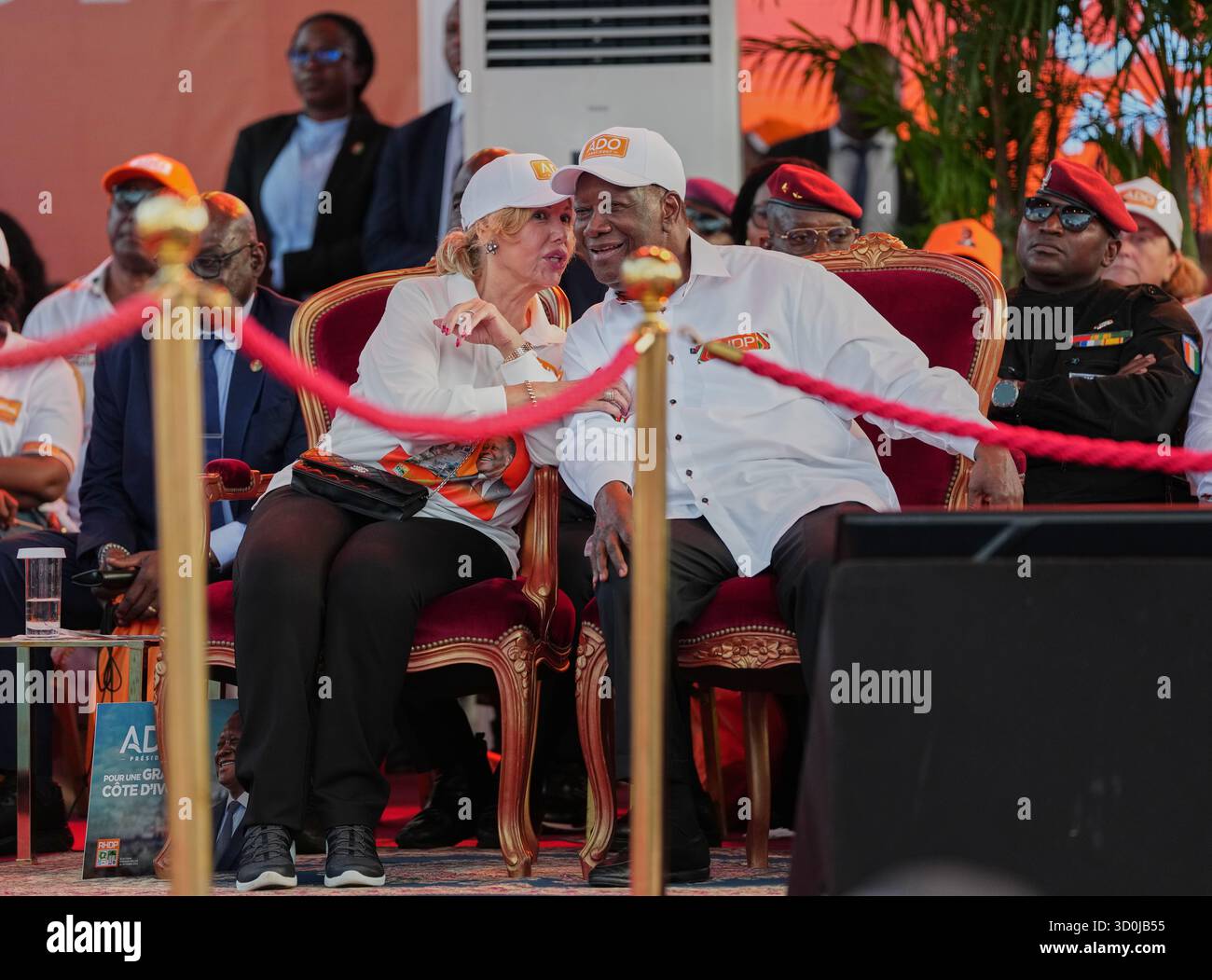 President Alassane Ouattara speaks with his wife, Dominique Ouattara ...