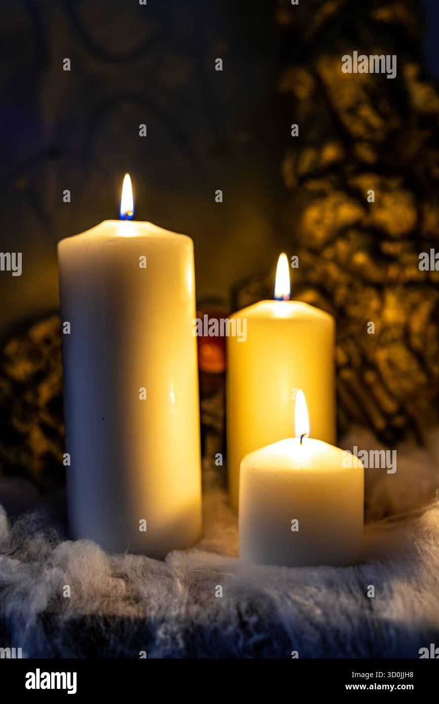 A collection of images featuring burning candles against a black ...