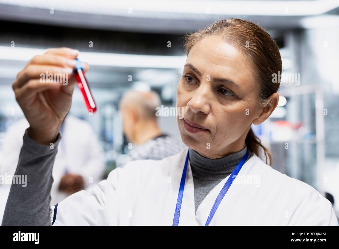 Woman researcher checks blood test sample during a laboratory ...