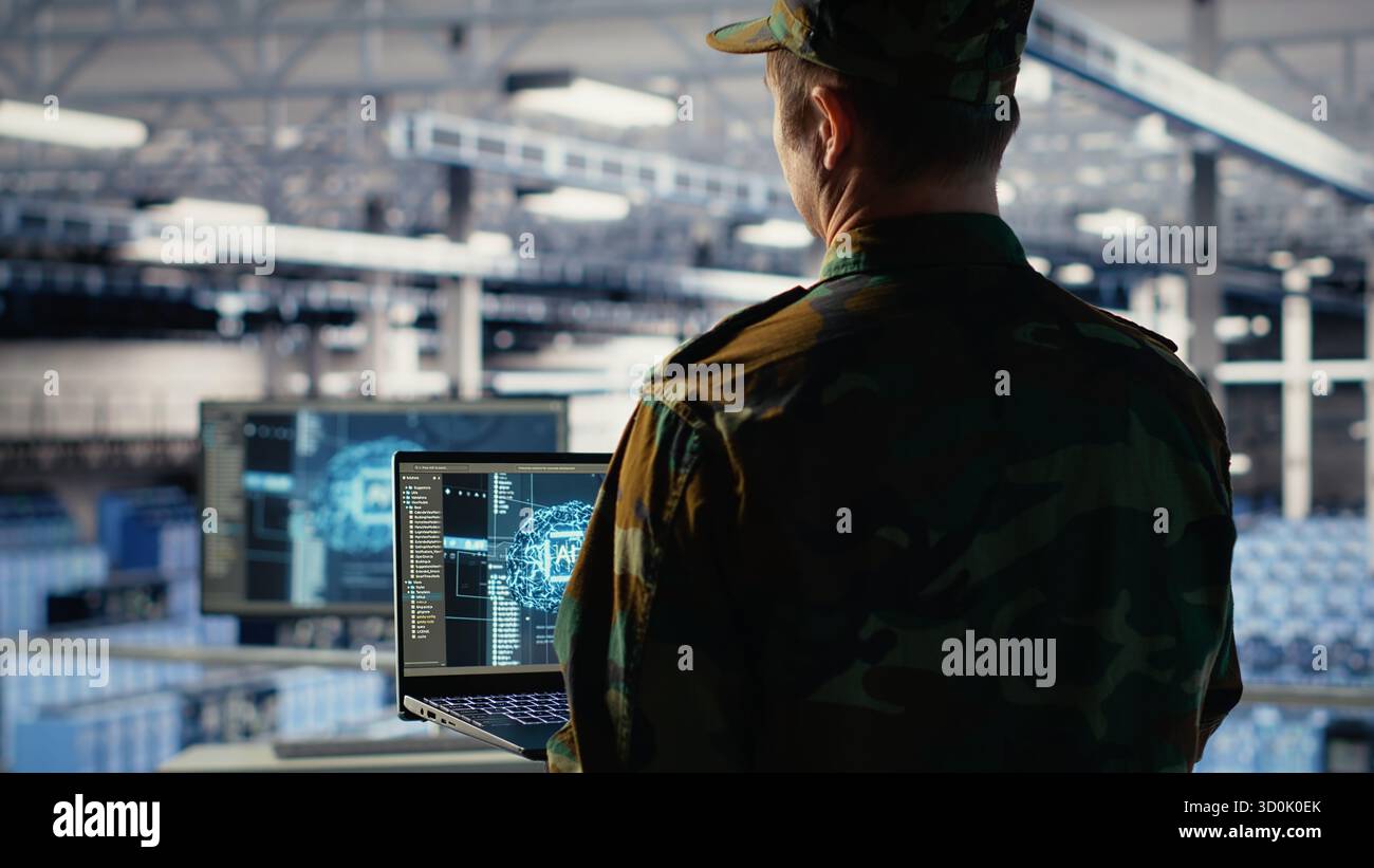 Army programmer in high tech server hub uses AI application on laptop to review reconnaissance ...