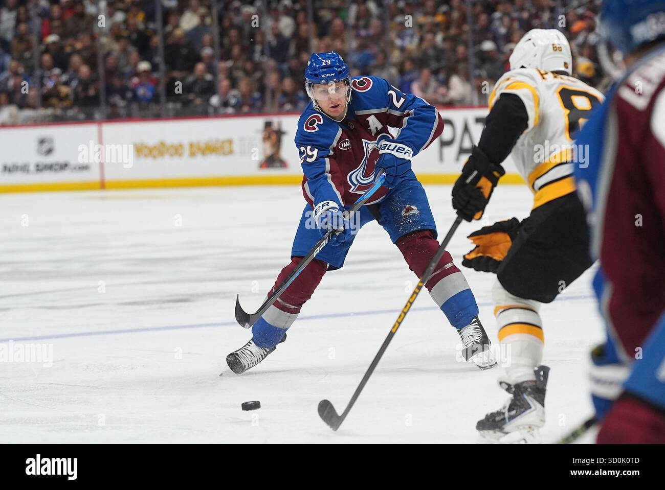 Colorado Avalanche center Nathan MacKinnon (29) passes the puck past ...