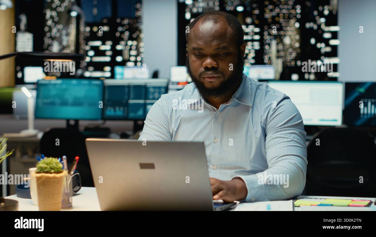 Business director reflects on a problem late at night after hours ...