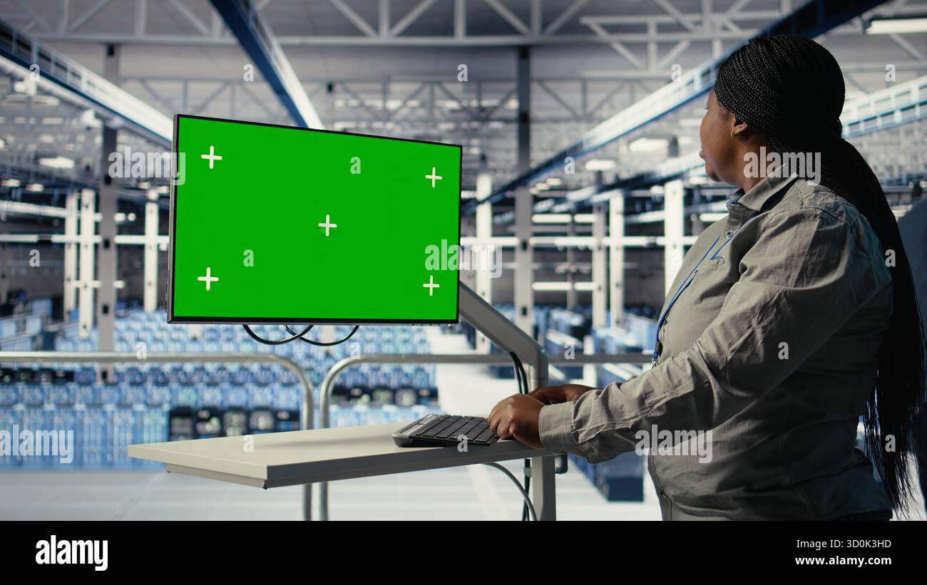 Technician uses computer workstation hi-res stock photography and ...