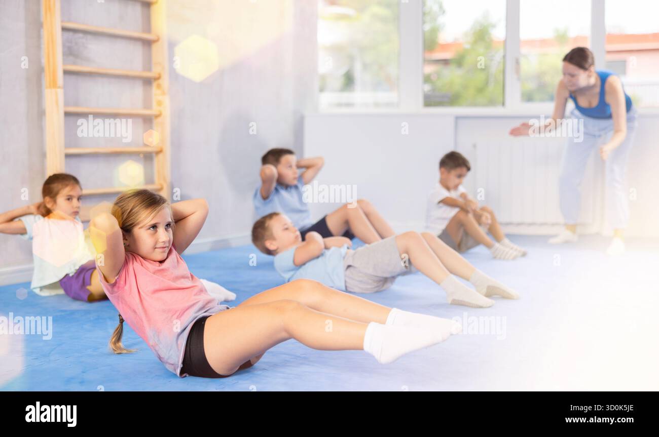 Children train their abdominal muscles during self-defense classes in ...