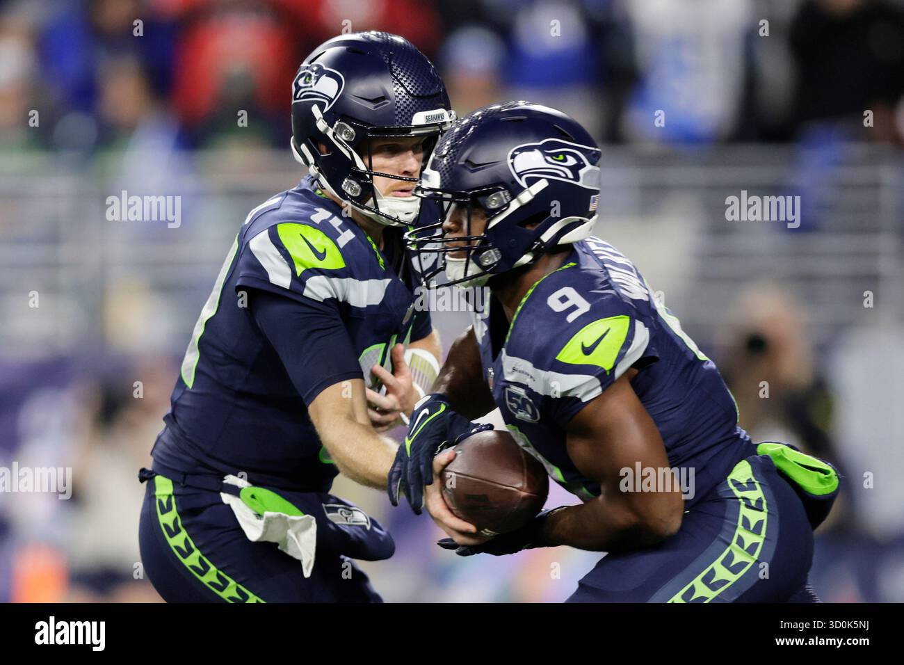 Seattle Seahawks quarterback Sam Darnold (14) hands off to running back ...