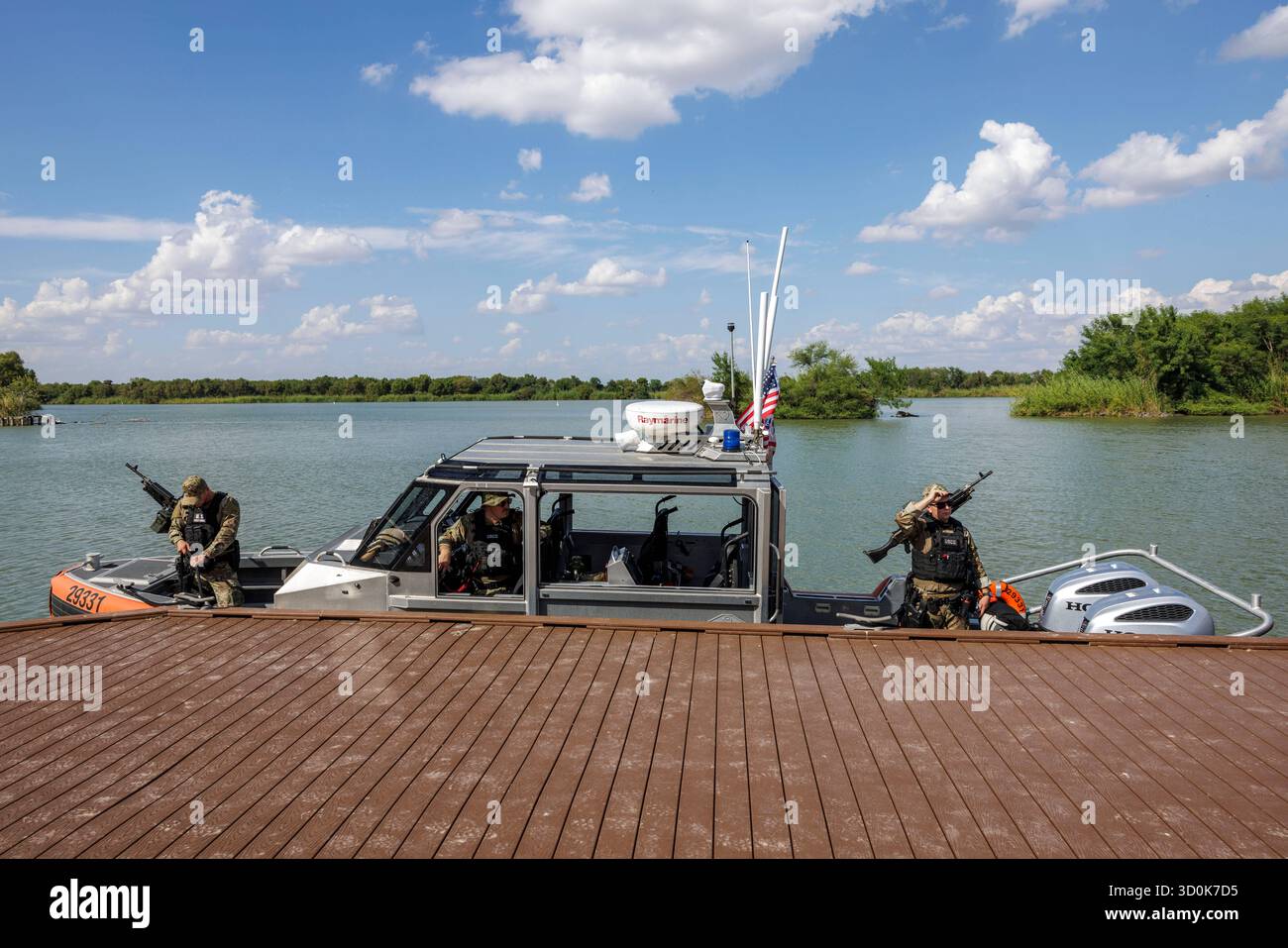 U.S. Coast Guard members prepare to patrol the Rio Grande River on ...