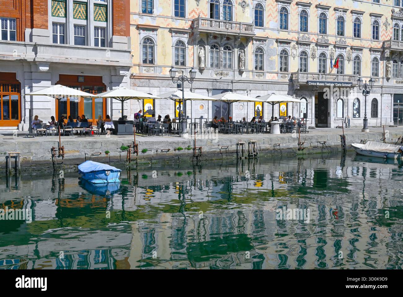 Weathered old buildings alongside the Canal Grande di Trieste in ...