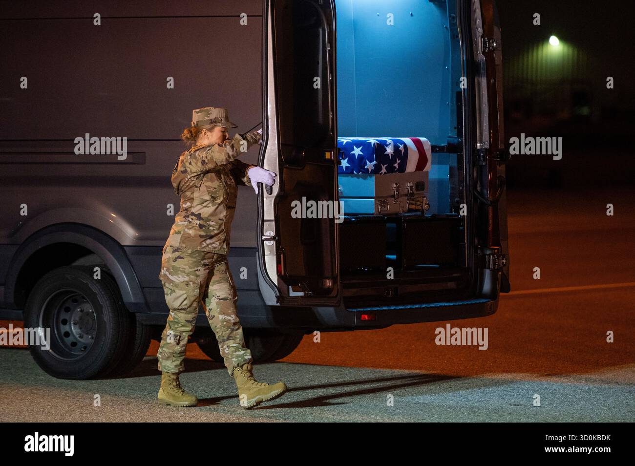 An Army carry team moves the transfer case containing the remains of ...