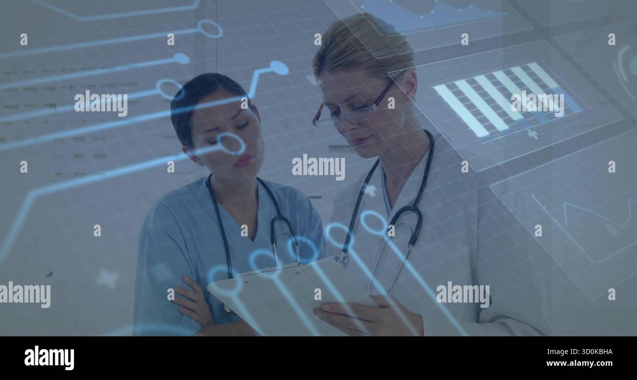 Analyzing medical staff in scrubs and coat discussing patient charts in ...