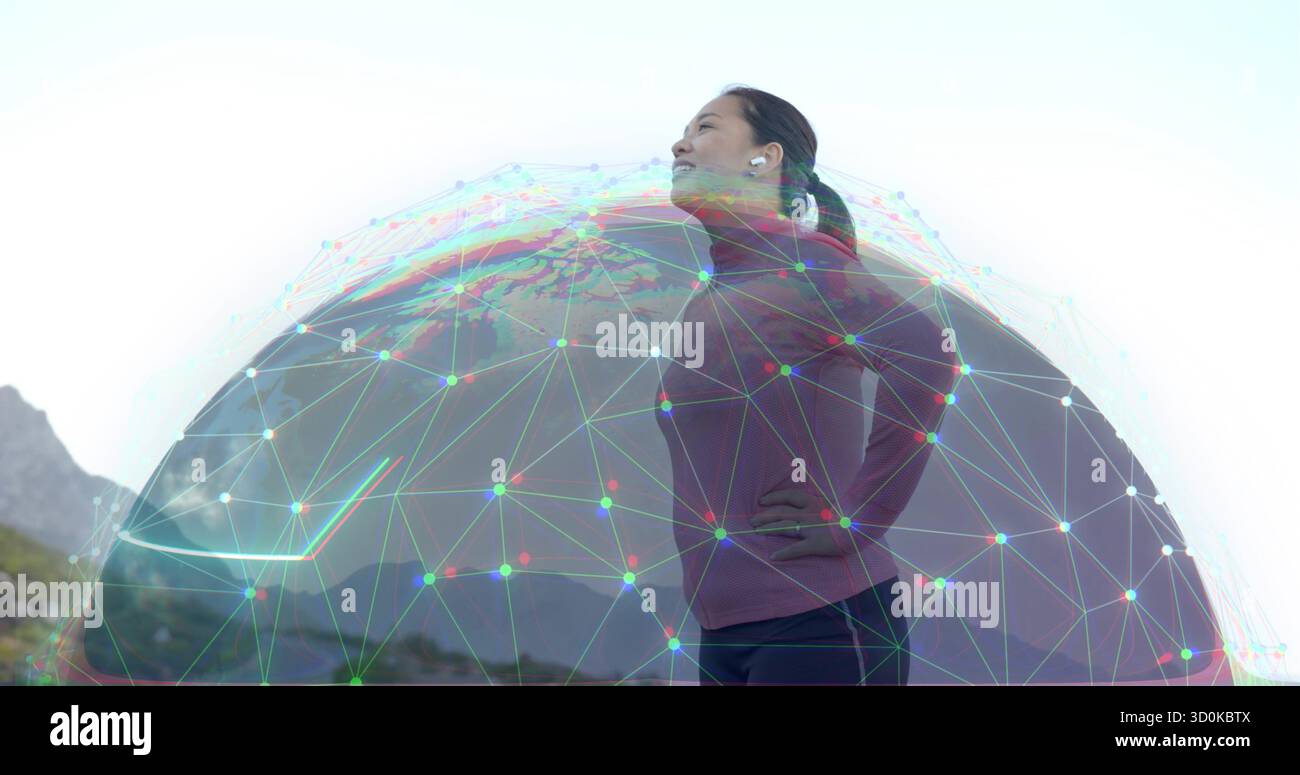 Standing Asian woman wearing activewear at mountain vista, with ...