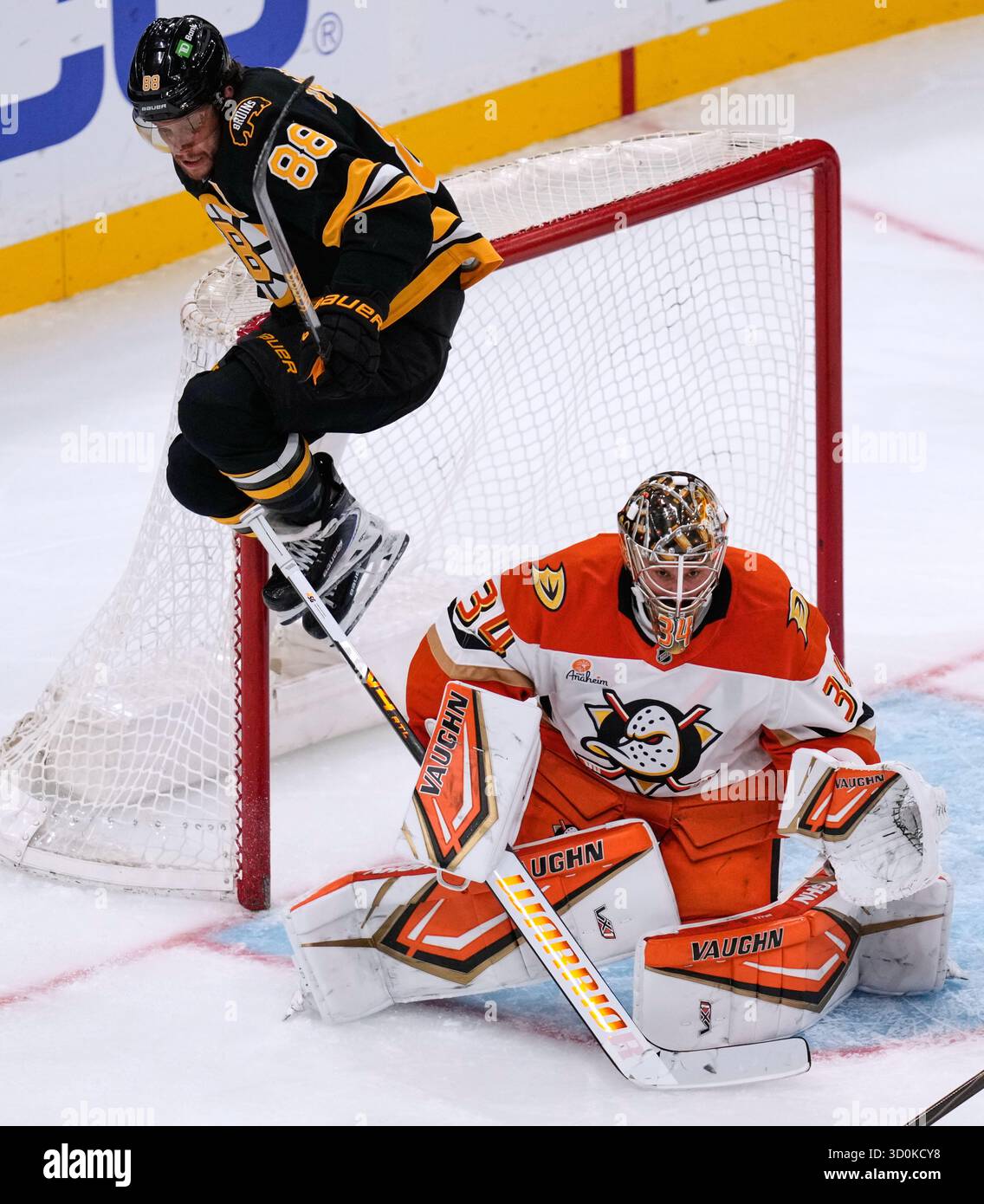 Boston Bruins right wing David Pastrnak (88) leaps over Anaheim Ducks ...