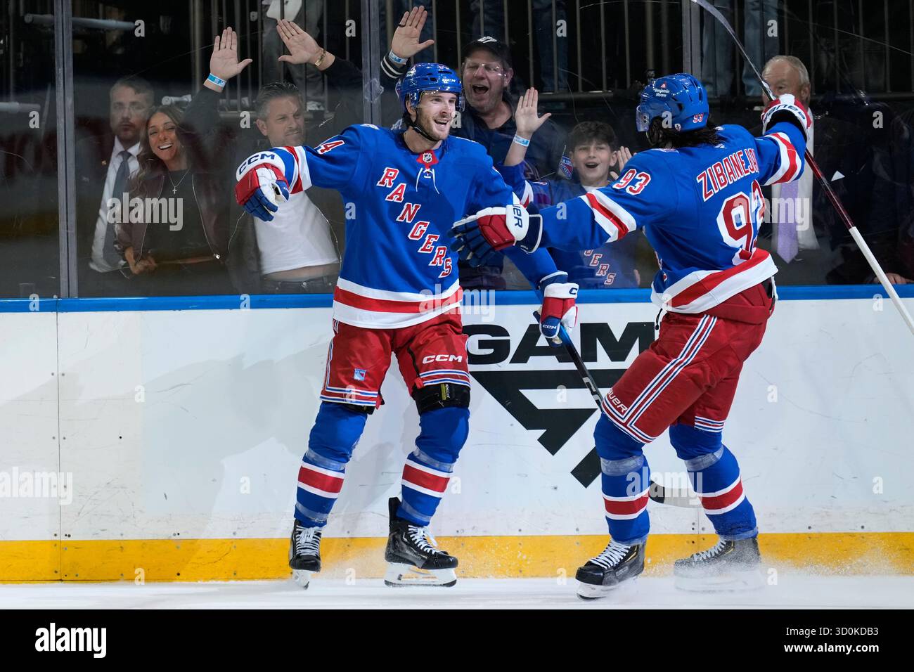 New York Rangers' Taylor Raddysh, left, celebrates his goal with Mika ...