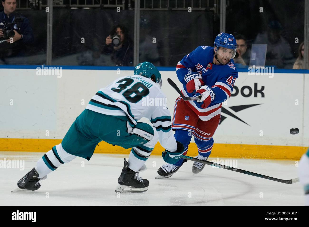 New York Rangers' Conor Sheary, right, passes past San Jose Sharks ...