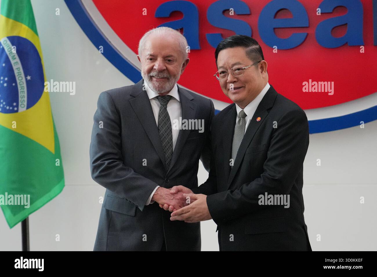 Brazil's President Luiz Inacio Lula da Silva, left, shakes hands with ...