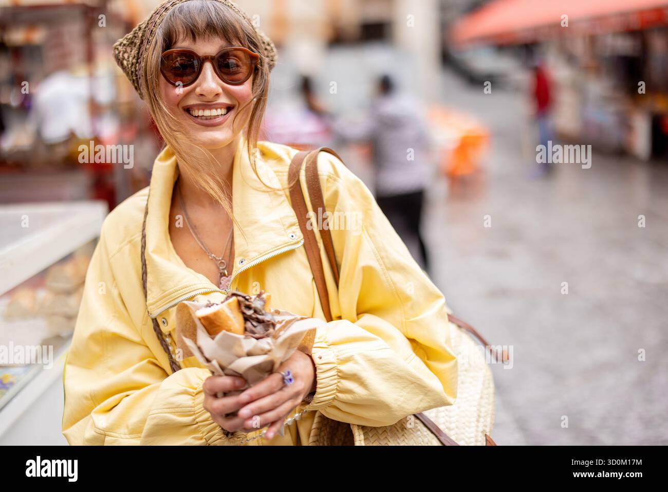 Smiling woman buying traditional Sicilian street food Pani ca Meusa ...
