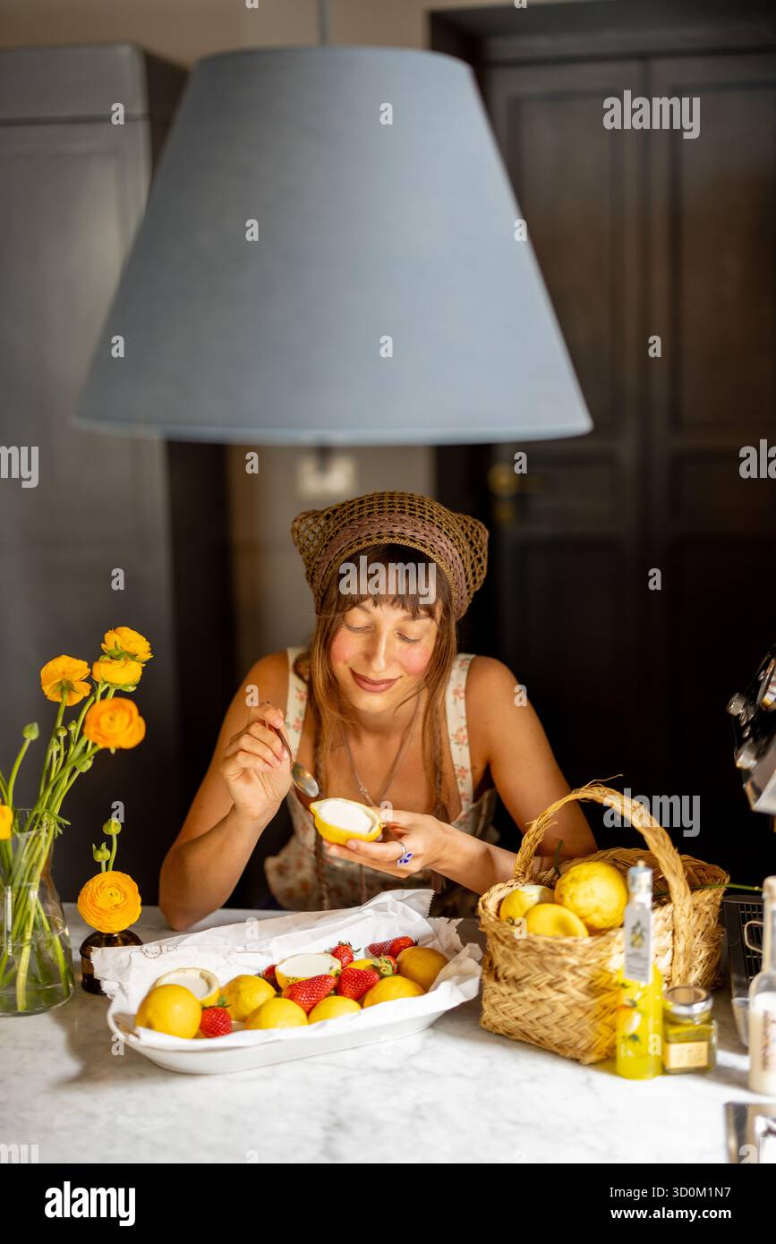 Woman tasting a homemade Sicilian lemon dessert in a cozy kitchen ...