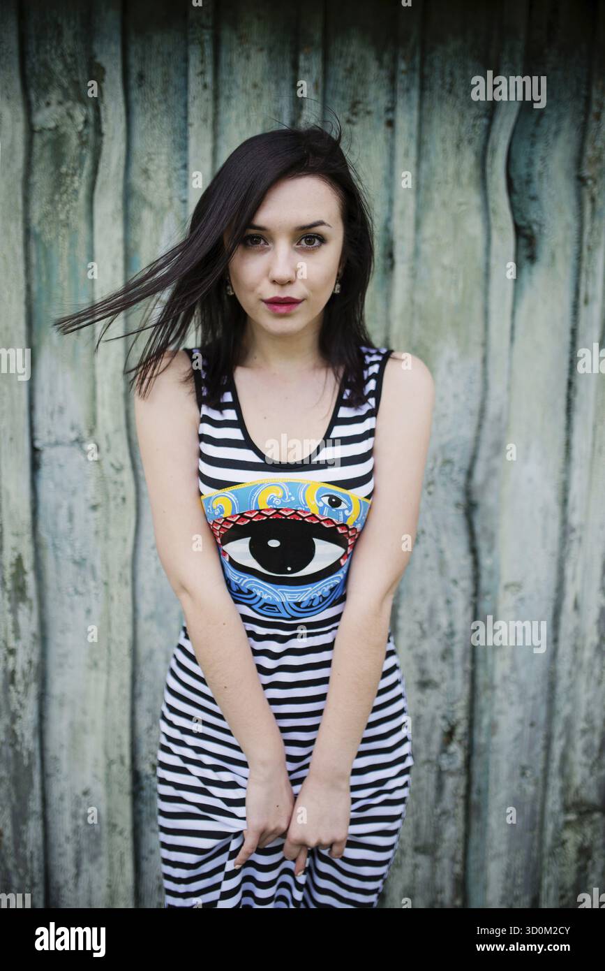 Brunette model girl at dress with stripes background cian wooden ...