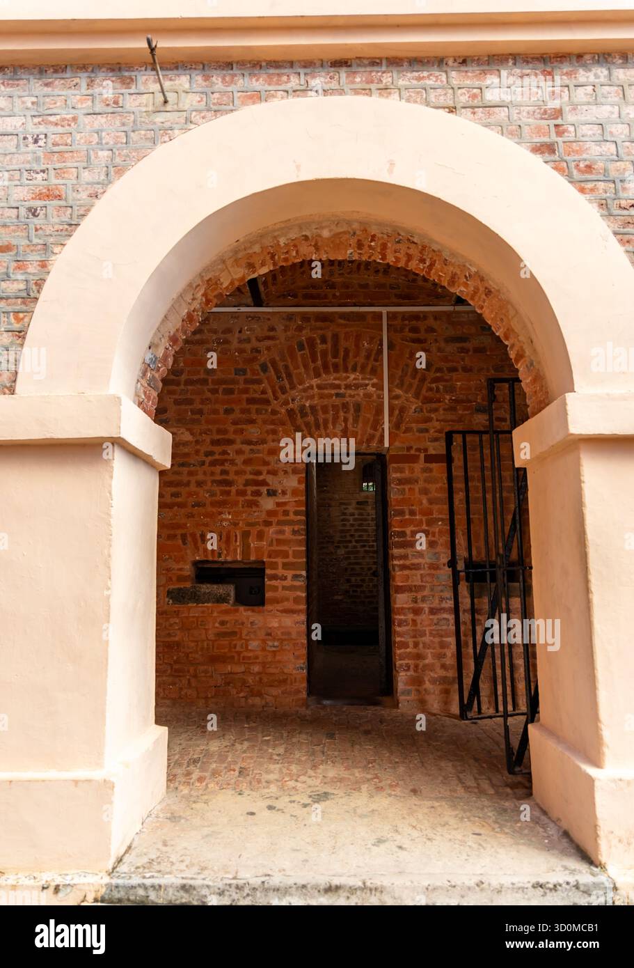 black metal bars and small arched window of a jail image is taken at ...